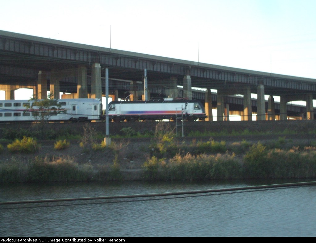 A midtown direct train heads for NY Penn on the PRR high line. Meanwhile the train this picture ...